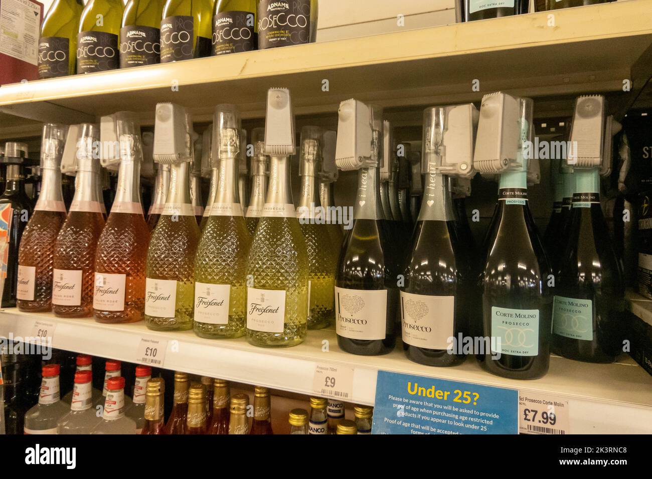 Bottles Of Wine And Spirit On A Shelf In A Supermarket With Security