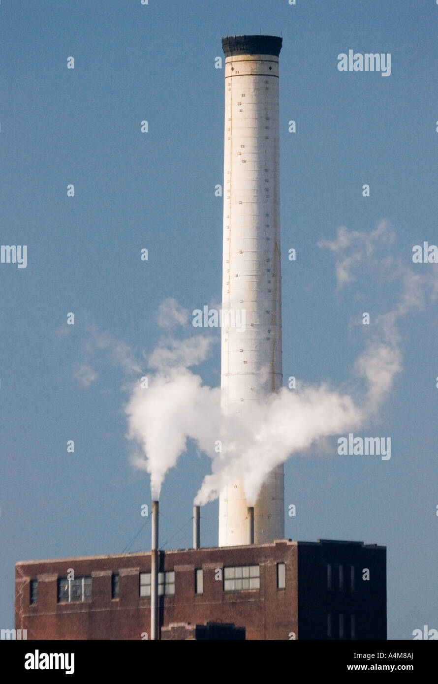 A tall smokestack rises above a brick factory building Stock Photo ... A tall smokestack rises above a brick factory building Stock Photo ...
