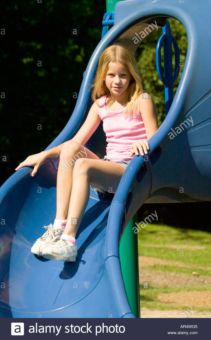 A Young Preteen Blond Girl Enjoys A Summers Afternoon In The Park Stock