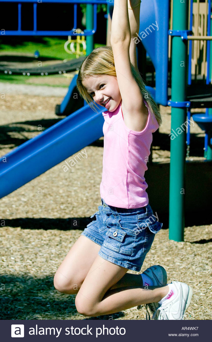 A Young Preteen Blond Girl Enjoys A Summers Afternoon In The Park Stock