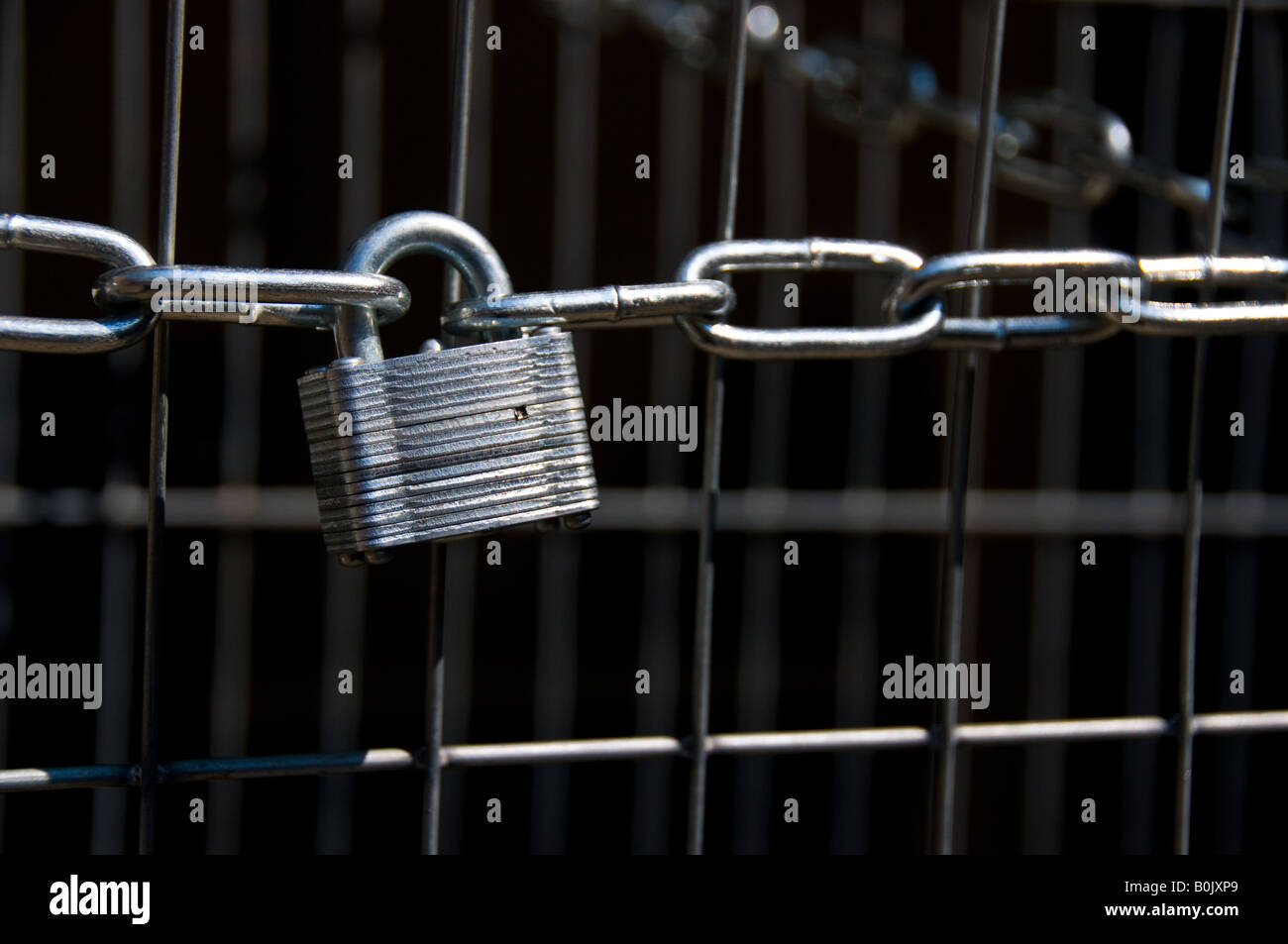 A padlock and chain attached to a metal grill Stock Photo, Royalty Free ... A padlock and chain attached to a metal grill Stock Photo, Royalty Free ...