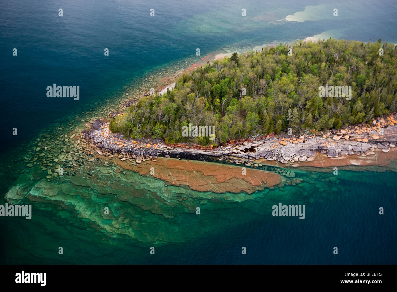 Aerial view of small rocky islands with a clear view through water to ... Aerial view of small rocky islands with a clear view through water to ...