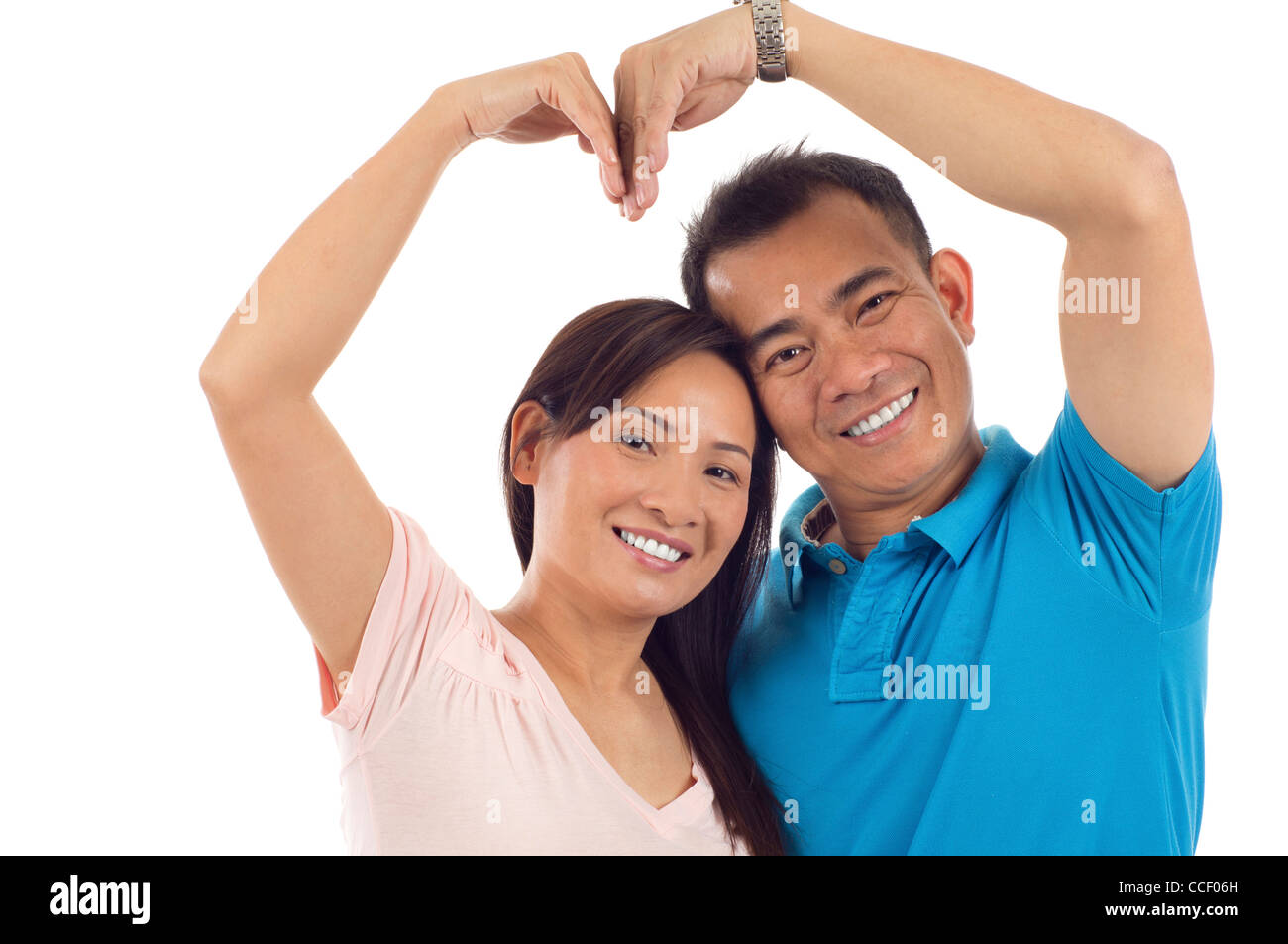 Asian Couple Making Heart Shape With Arms Isolated Over White Stock