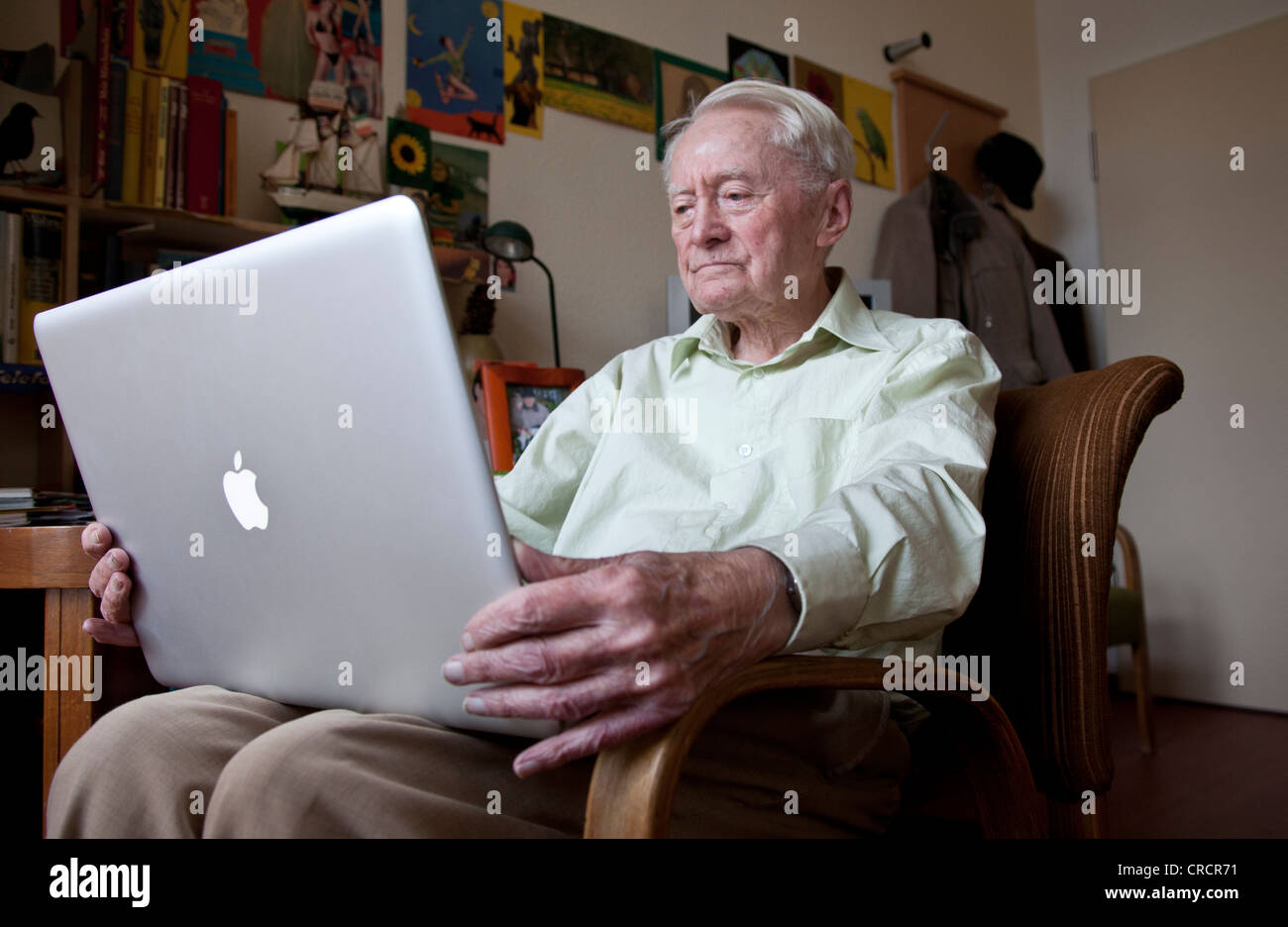 Elderly man, senior citizen holding an Apple Macintosh laptop Stock ... Elderly man, senior citizen holding an Apple Macintosh laptop Stock ...