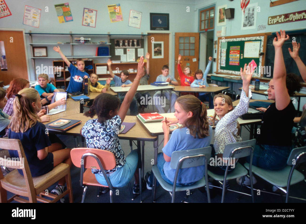 6Th Grade Elementary School Students Raising Hands In Classroom Stock 6Th Grade Elementary School Students Raising Hands In Classroom Stock