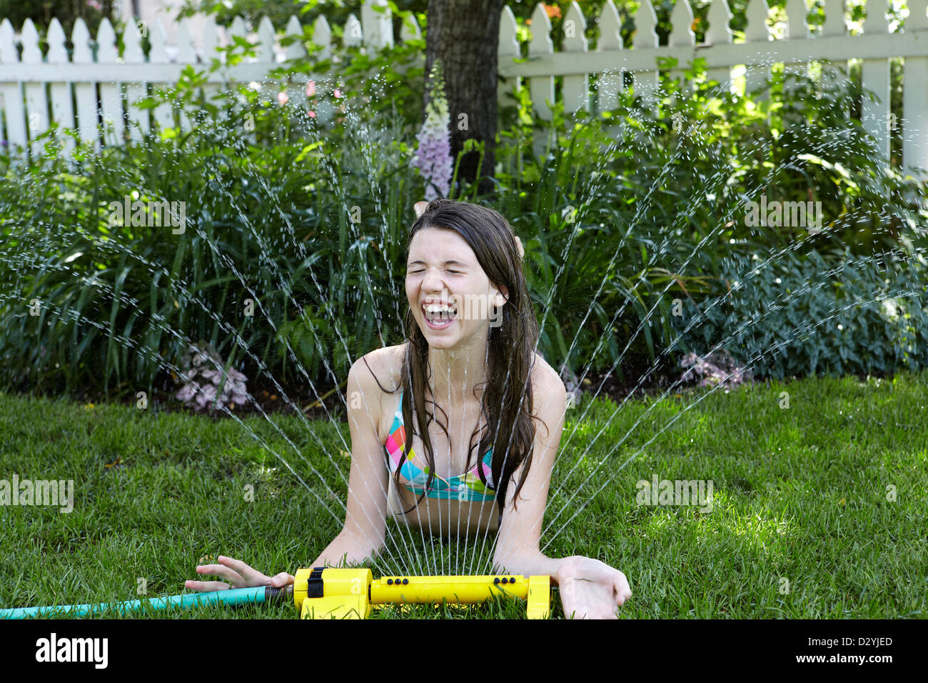 12 Year Old Girl Playing With Water Sprinkler Stock Photo Royalty Free 12-year-old-girl-playing-with-water-sprinkler-stock-photo-royalty-free