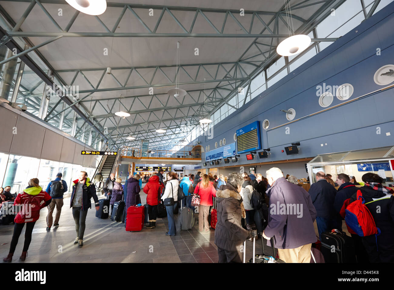 passengers queuing at check in desks in Tromso airport troms Norway ... passengers queuing at check in desks in Tromso airport troms Norway ...