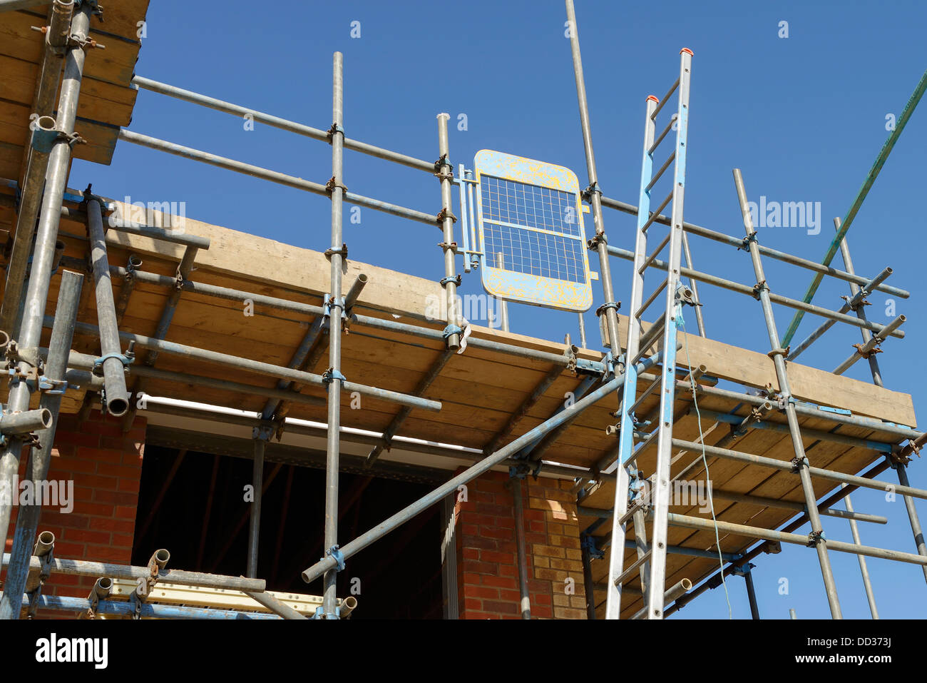 Scaffolding and a ladder access safety gate on a building site Stock ... Scaffolding and a ladder access safety gate on a building site Stock ...