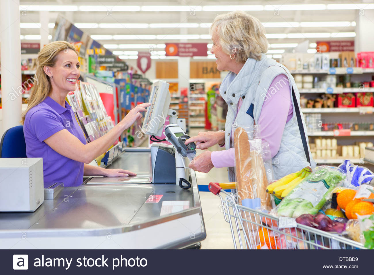 Cashier Serving Customer At Supermarket Checkout Stock Photo, Royalty ... Cashier Serving Customer At Supermarket Checkout Stock Photo, Royalty ...