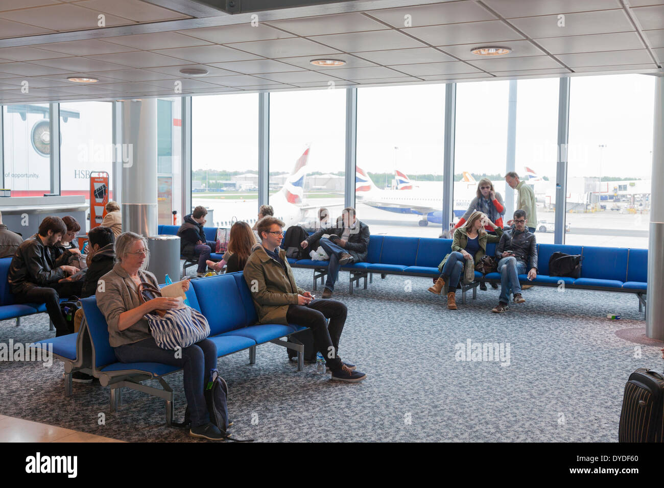 Passengers waiting in airport departure lounge at Gatwick Airport Stock ... Passengers waiting in airport departure lounge at Gatwick Airport Stock ...