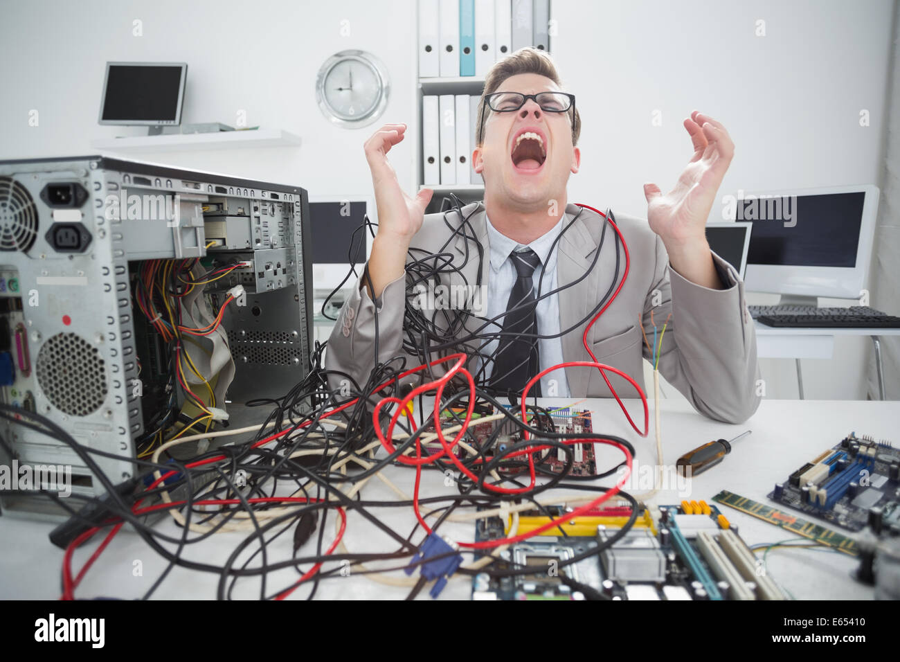 Stressed computer engineer working on broken cables Stock Photo ... Stressed computer engineer working on broken cables Stock Photo ...