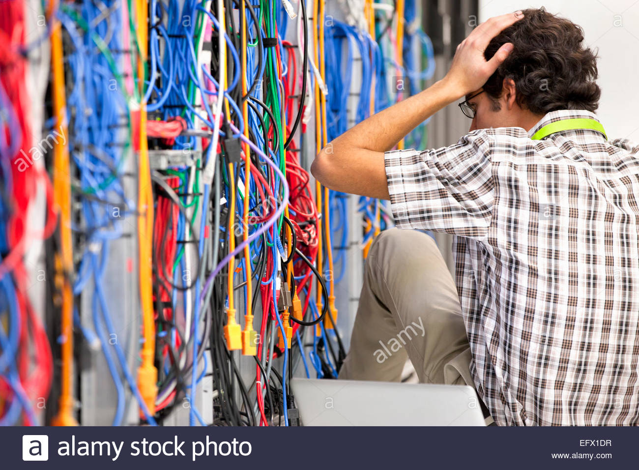 Frustrated technician working in Server room of data center Stock Photo ... Frustrated technician working in Server room of data center Stock Photo ...