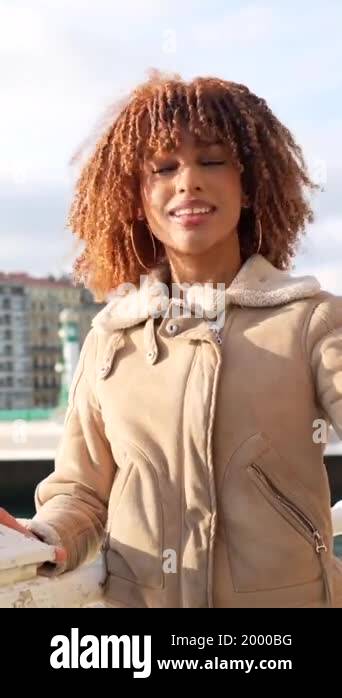 Beauty female latin traveler vlogging with phone next to a river in the ...