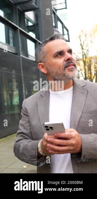 Businessman waiting for a call, checking his phone, and then receiving ...