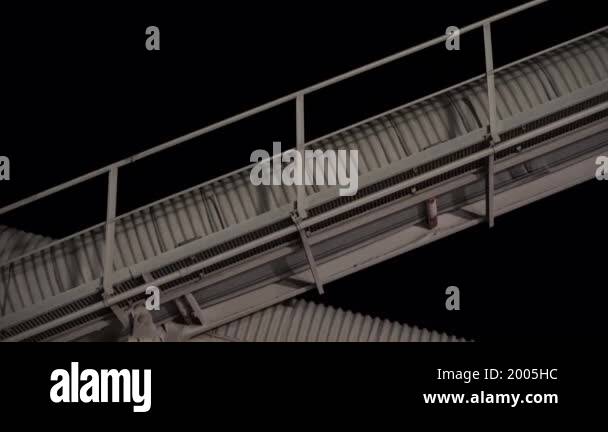 A metal structure with a railing and a person on it. The railing is ...