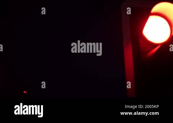 A black background with a red object in the foreground. The red object ...