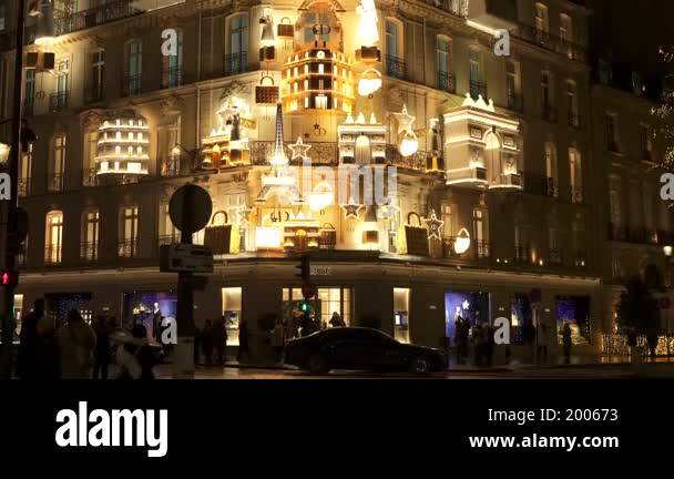 Paris, France 12.20.2024 The Dior store adorned with glowing golden ...