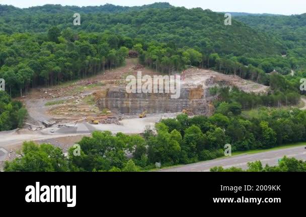 Aerial view of open pit mining site of limestone materials extraction ...