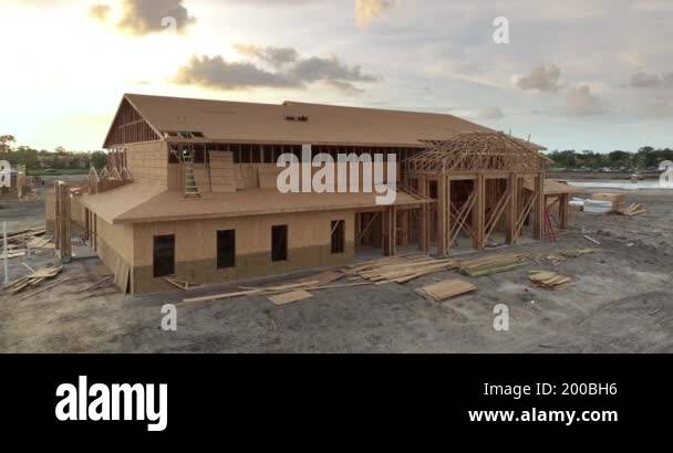 Wooden apartment building under construction in new developing suburban ...