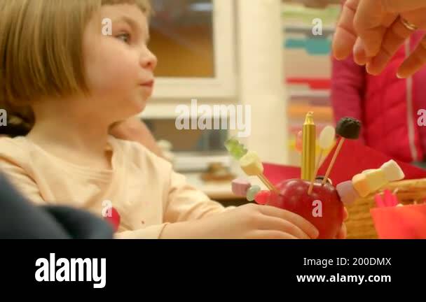 A child joyfully participates in a fun classroom activity with edible ...
