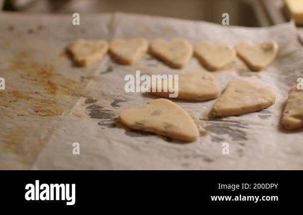 Various dough shapes are laid out on parchment paper as part of the ...
