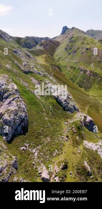 Flight over the rocky landscape with poor scarce vegetation. Turquoise ...