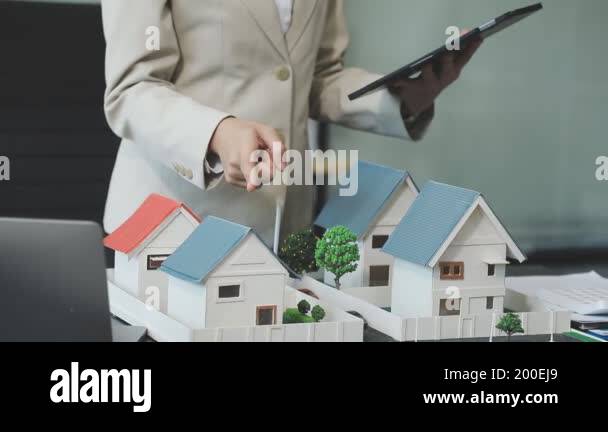 real estate agent holding model house model and model house model on ...