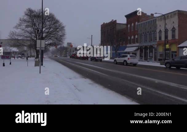 Charlotte MI - November 30, 2024: Downtown Traffic During Snowfall ...