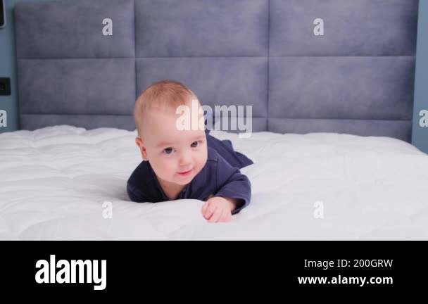 A New born amazed active baby boy begins to roll over Child development ...