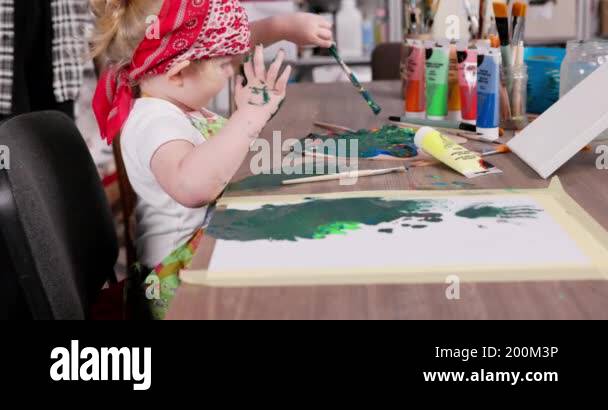 A young and enthusiastic artist deeply immersed in painting brings ...