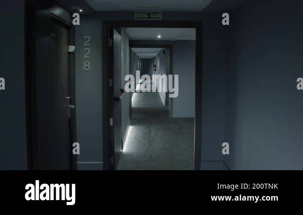 Camera gliding through a dark, modern hotel corridor, showcasing ...