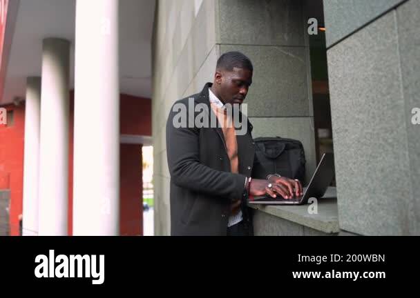 Young african entrepreneur leveraging mobile technology, working on ...