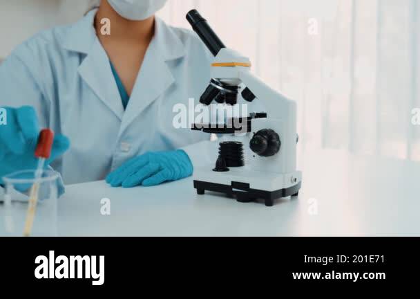 Scientific laboratory researcher drop liquid sample on microscopic ...