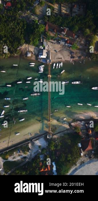 Aerial view of a bridge connecting two tropical islands over a narrow ...