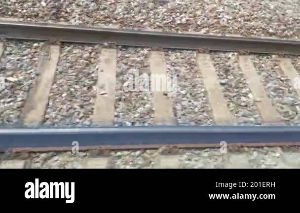Railroad tracks set against a gravel bed, showcasing the rugged ...