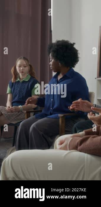 Vertical medium wide shot of young African American psychologist ...