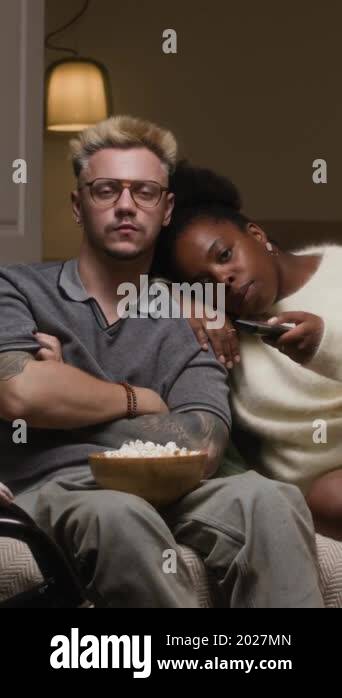 Vertical of young Black woman leaning on shoulder of young Caucasian ...