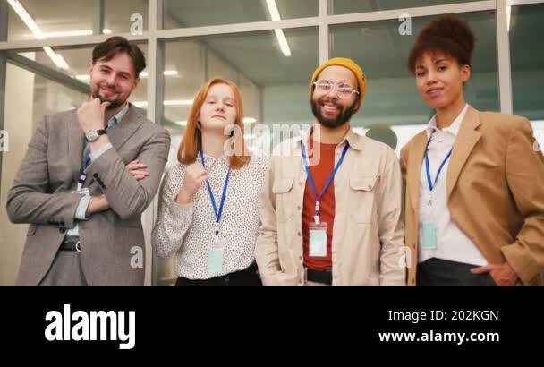 Smiling diverse colleagues men and women in formal attire pose in ...