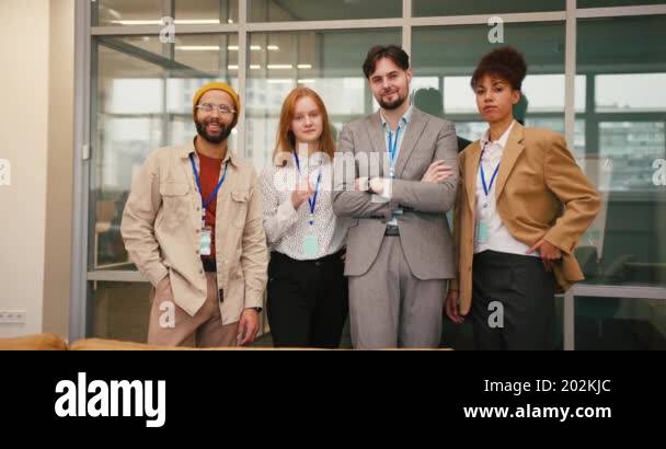 Smiling diverse colleagues men and women in formal attire pose in ...
