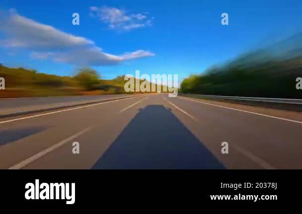 Timelapse of road drive along the highway. Front view to the road and ...