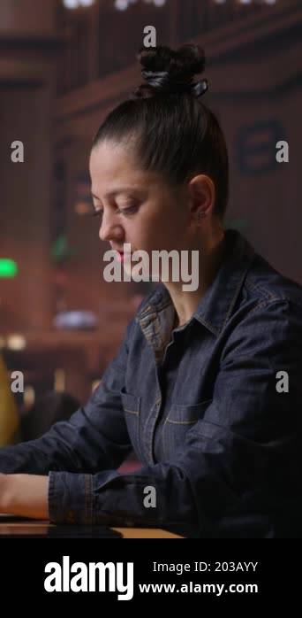 Vertical Video Rude woman answering a phone call in the library and ...