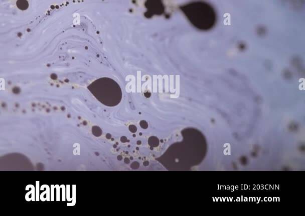 Bubble paint. Acid liquid. Defocused purple color oil emulsion leak ...