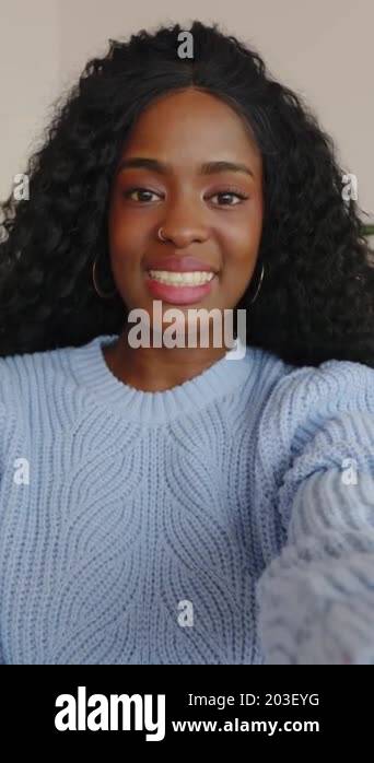 Vertical Video. POV of young woman having an online video call using ...