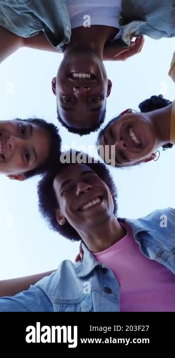 Low angle view of young group of Latin American friends standing ...