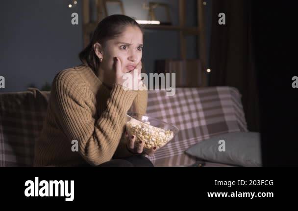 Woman watching tv with shocked expression bad news negative emotions ...