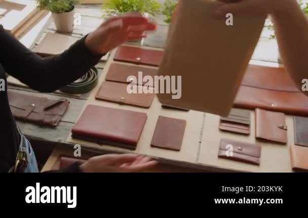 Woman receiving her custom-made order in brown-wrapped package near ...