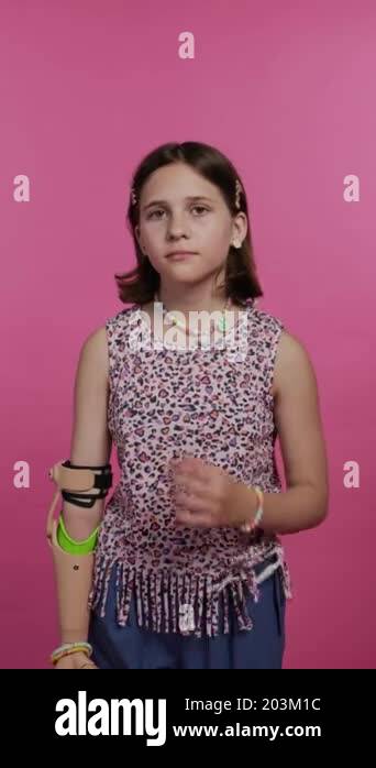 Vertical portrait of serious gen alpha girl with prosthetic arm ...