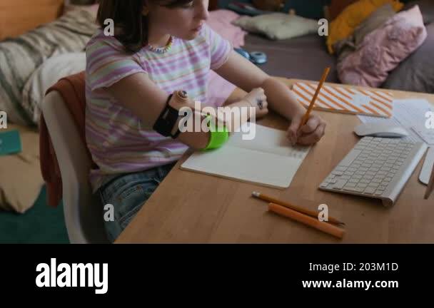 Tilt up view of diligent student with disability copying theorem from ...
