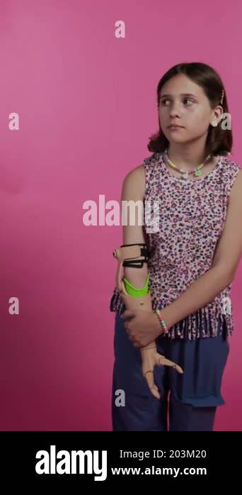 Vertical view of gen alpha girl with disability looking at both sides ...
