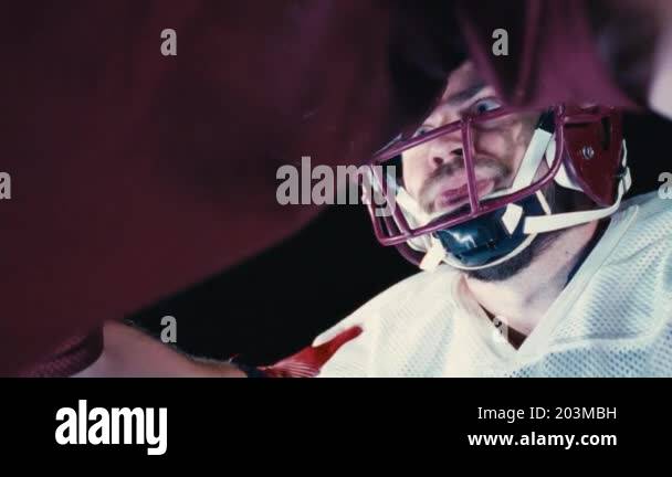 A dramatic moment as two American football players face off, helmets ...